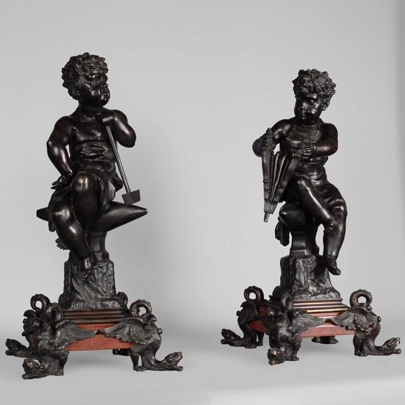 Pair of antique bronze and red andirons representing small blacksmiths ...