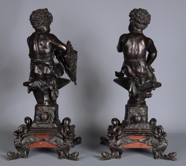 Pair of antique bronze and red andirons representing small blacksmiths ...