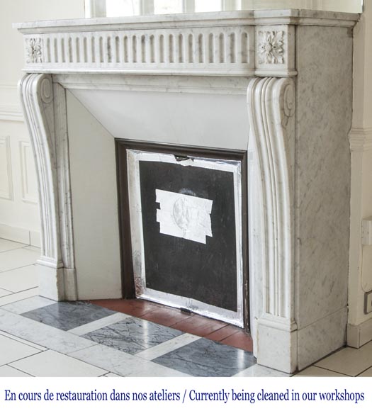 An antique Louis XVI style fireplace with flutes, made out of Carrara ...
